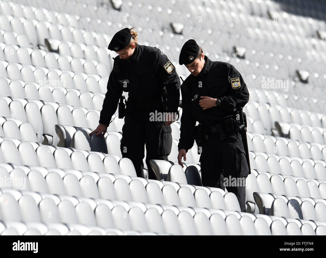 Munich, Germany. 29th Mar, 2016. Police officers check the seating rows ...