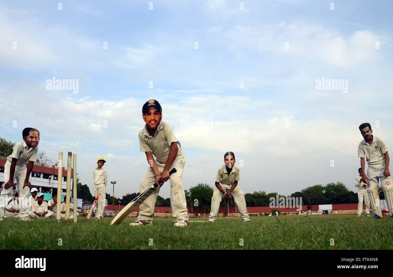 Children wear mask of Indian Cricket players during their practice for ...