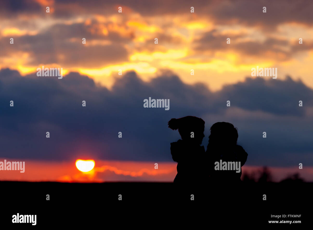 Two adorable children, boy brothers, watching beautiful splendid sunset ...