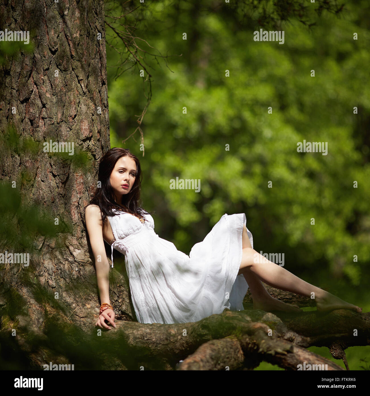 beautiful girl on old tree Stock Photo - Alamy