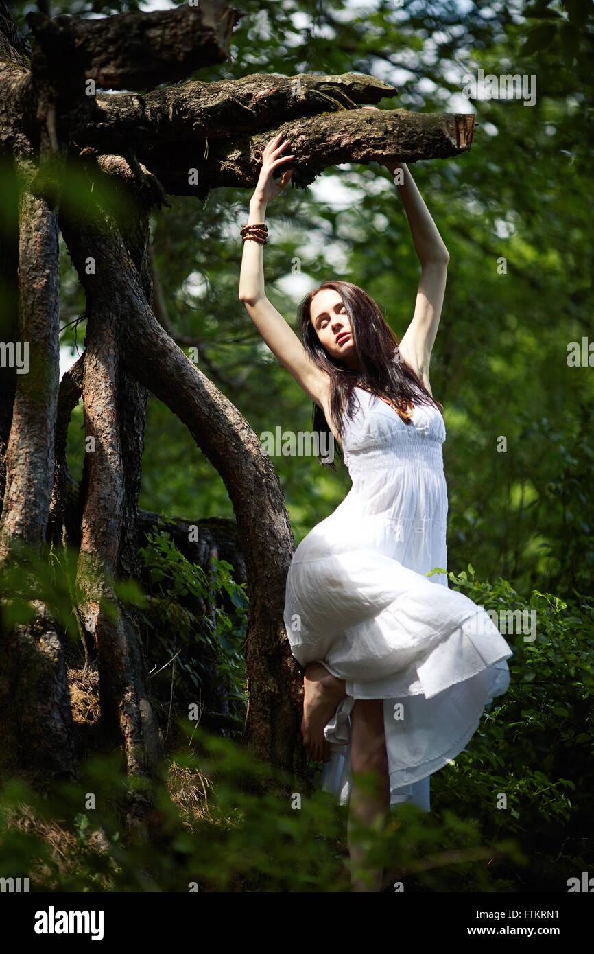 beautiful girl on old tree Stock Photo - Alamy