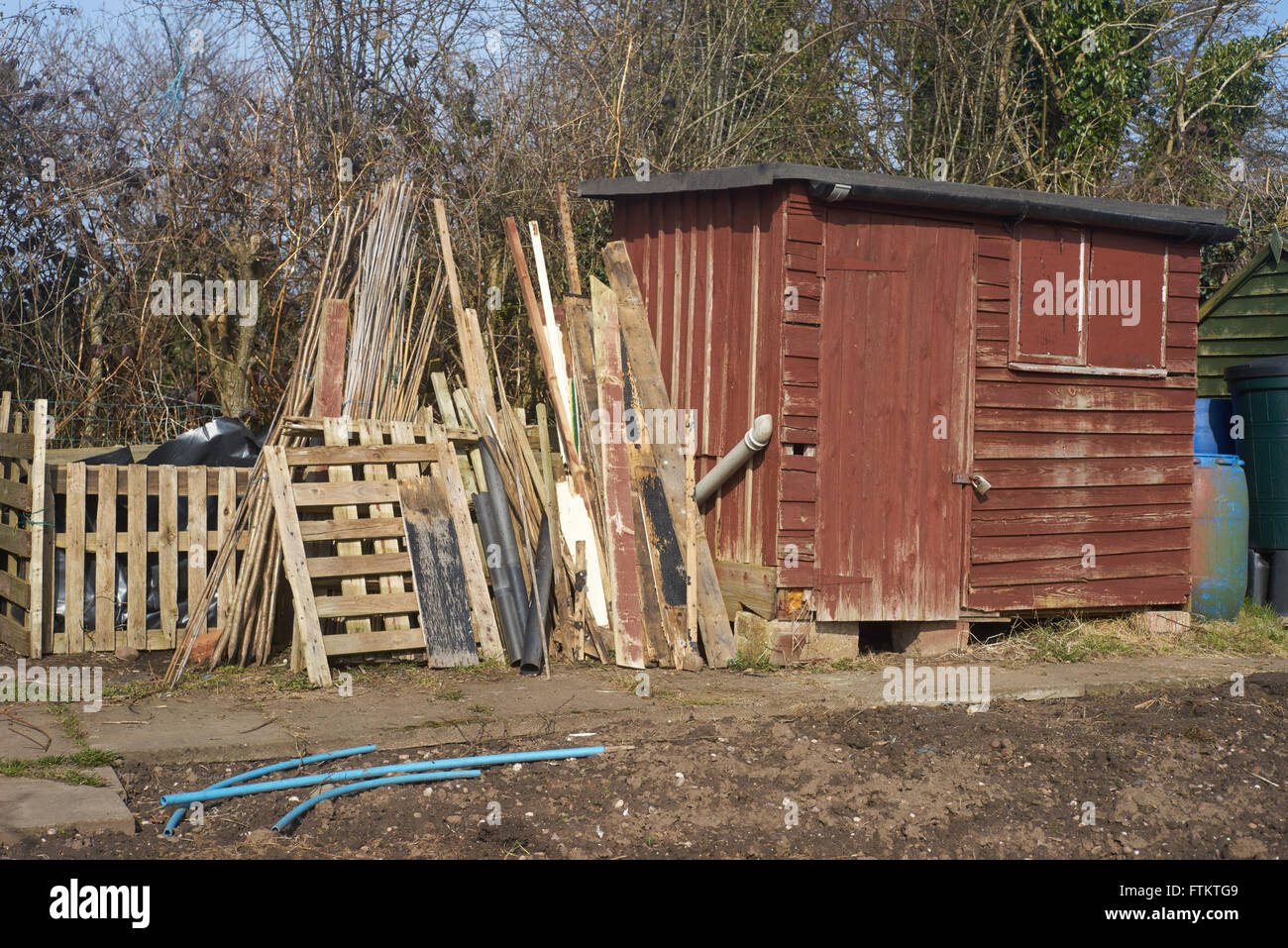 Brown weathered urban allotment shed with wooden canes and pallets ...