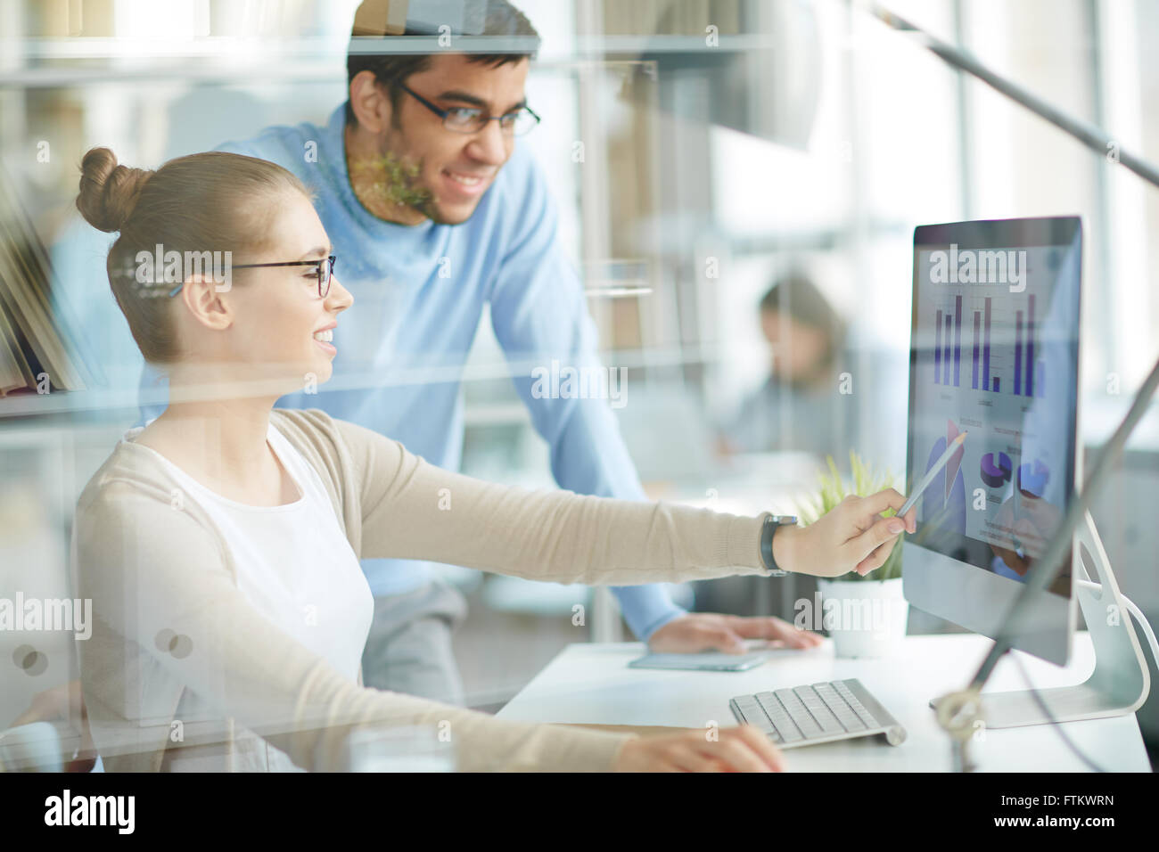 Pointing at monitor Stock Photo - Alamy