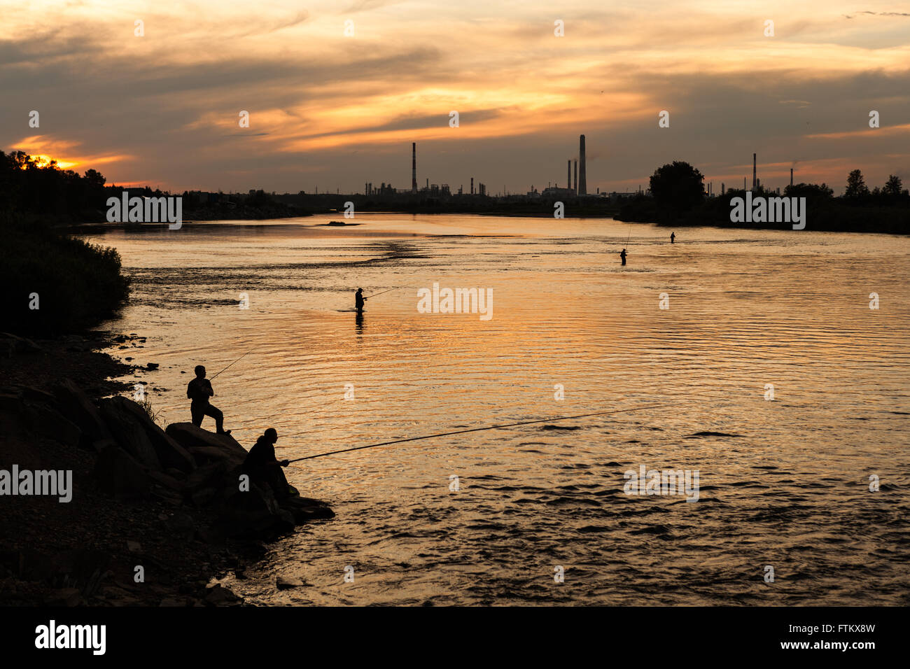 Fishing in unclean water. A big factory spoiled water in the river ...