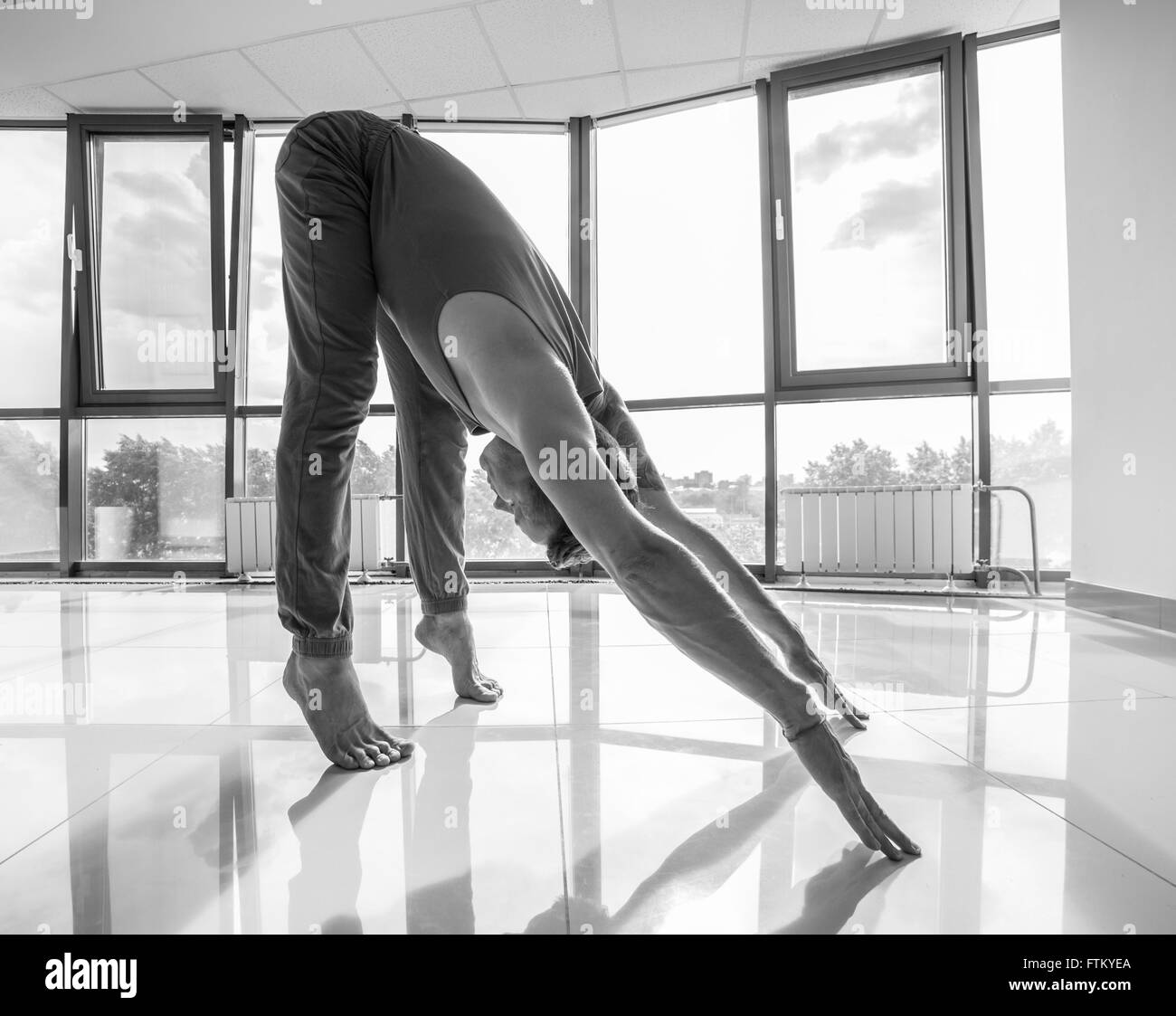 Athletic muscular young man working out, yoga, pilates, fitness ...