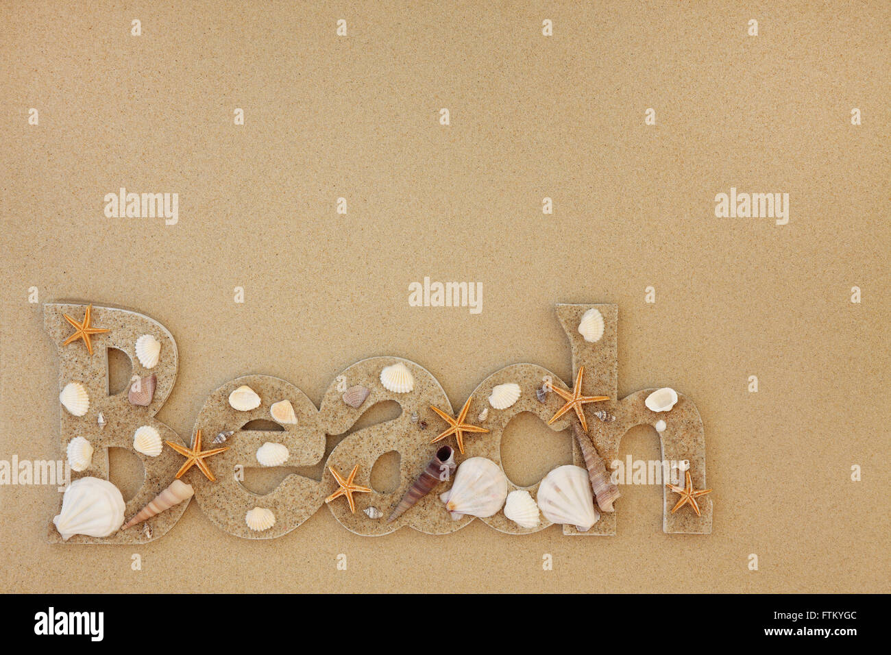 Beach sign with sea shells on sand background Stock Photo - Alamy