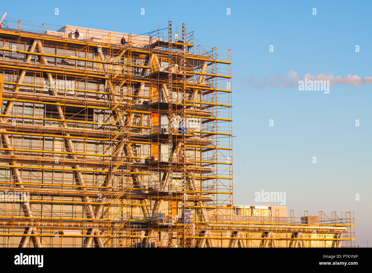 Modern building under construction with blue sky Stock Photo - Alamy