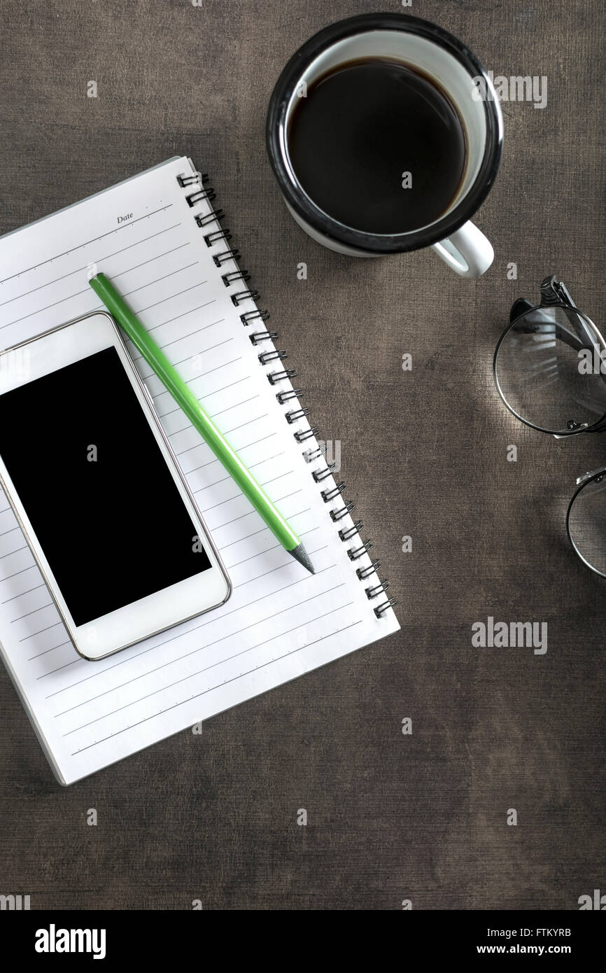Wood desk with a notebook and working setup Stock Photo - Alamy