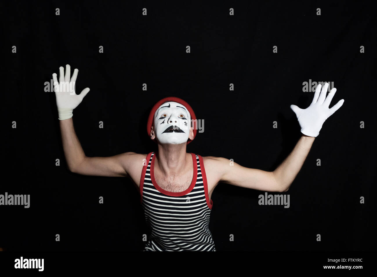 Portrait of sad mime wearing hat on black background Stock Photo - Alamy