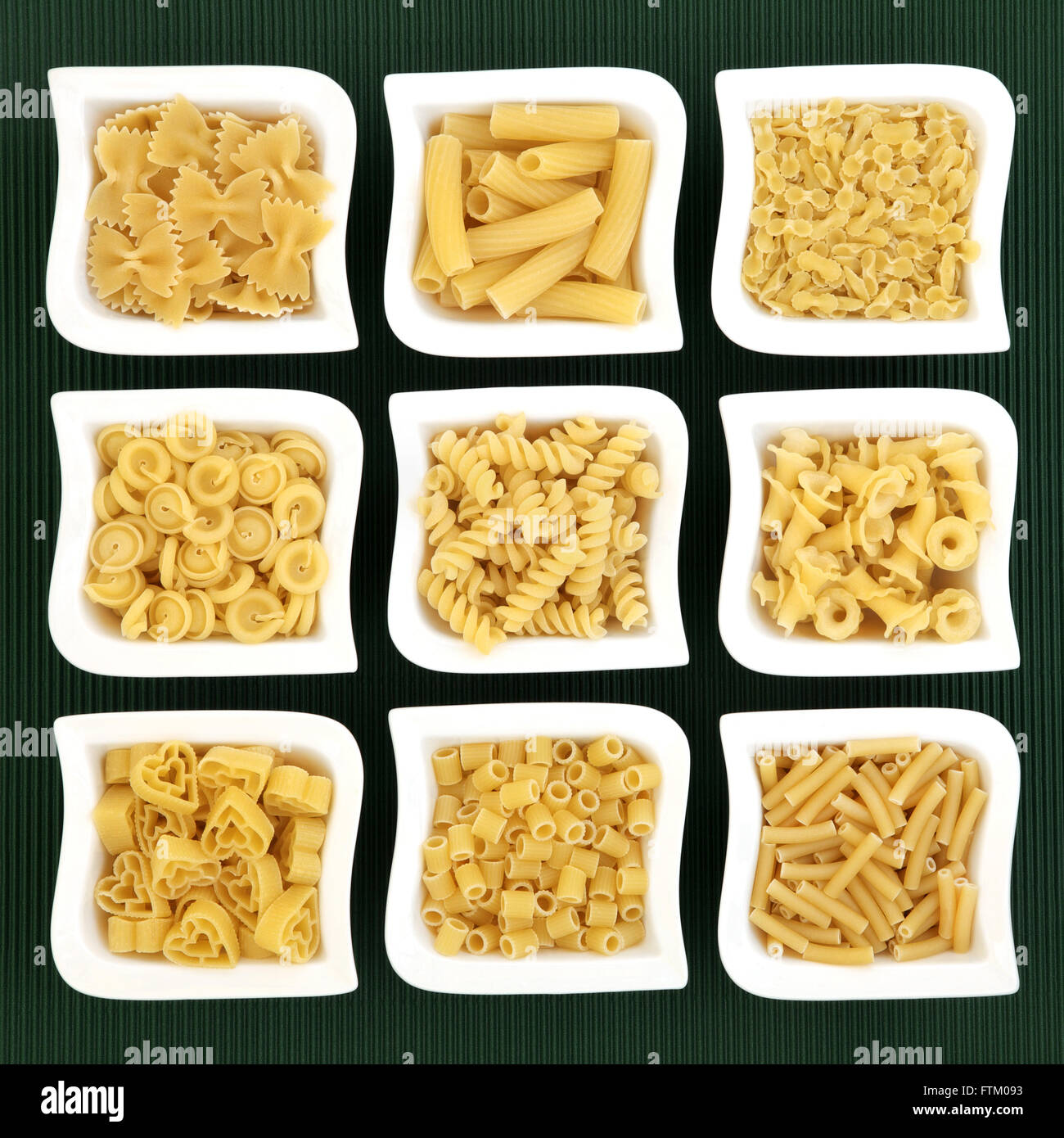 Italian dried food pasta selection in white porcelain dishes over ...