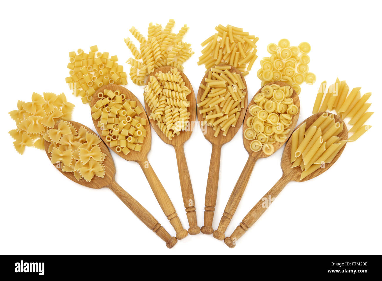 Dried pasta food in oak wood spoons and loose over white. Farfalle ...