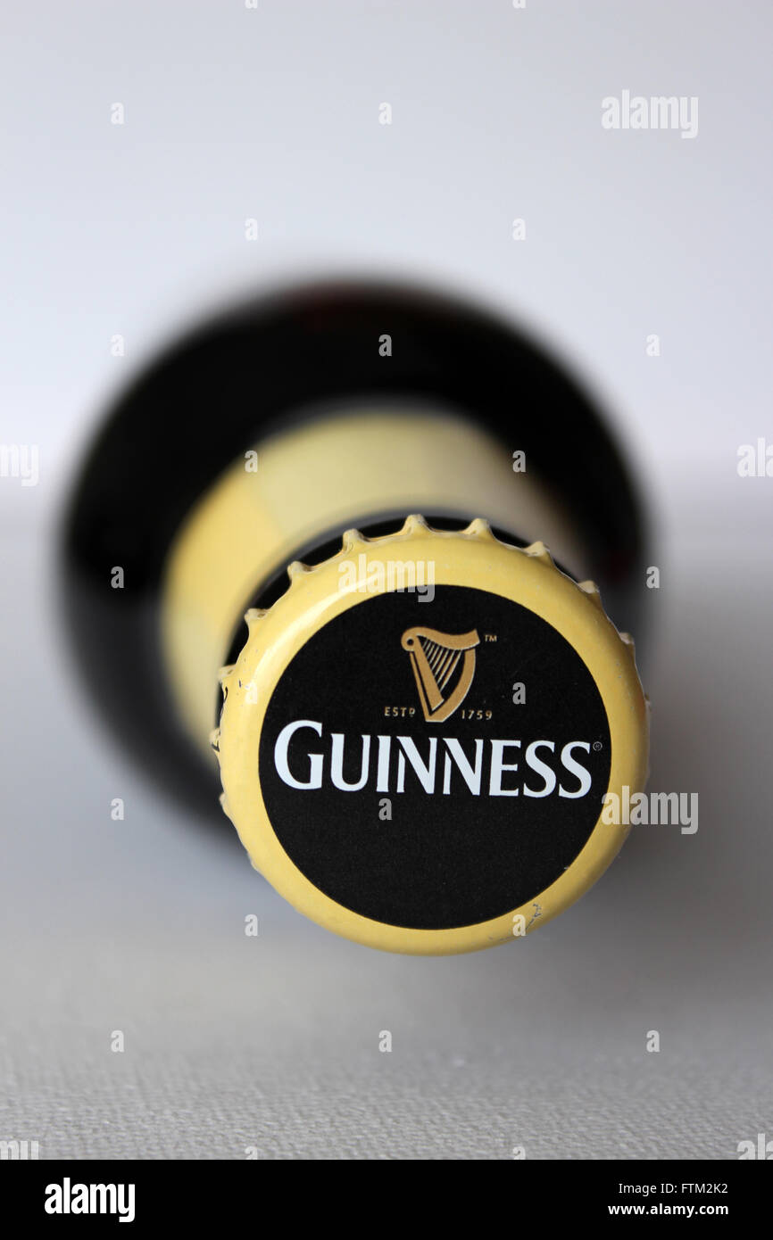 A Guinness Bottle on its side showing the Bottle top Stock Photo - Alamy