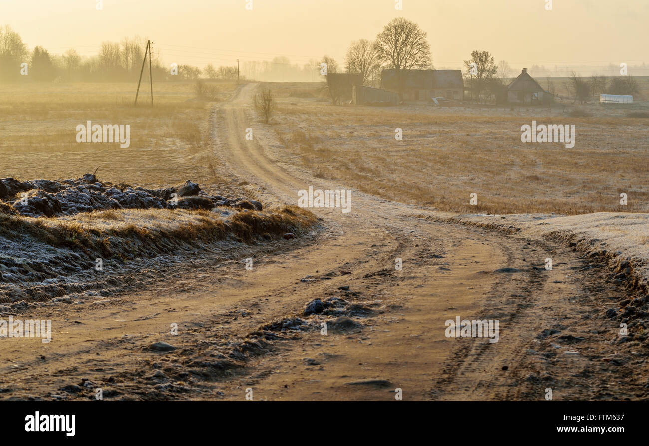 Non rural, countryside scene with dirt road and farm houses in the ...