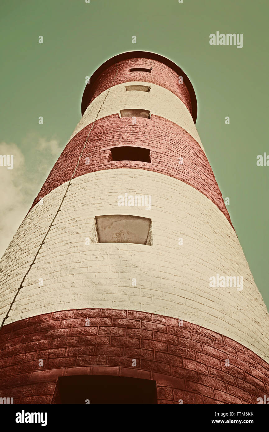 High lighthouse tower on the sky background Stock Photo - Alamy