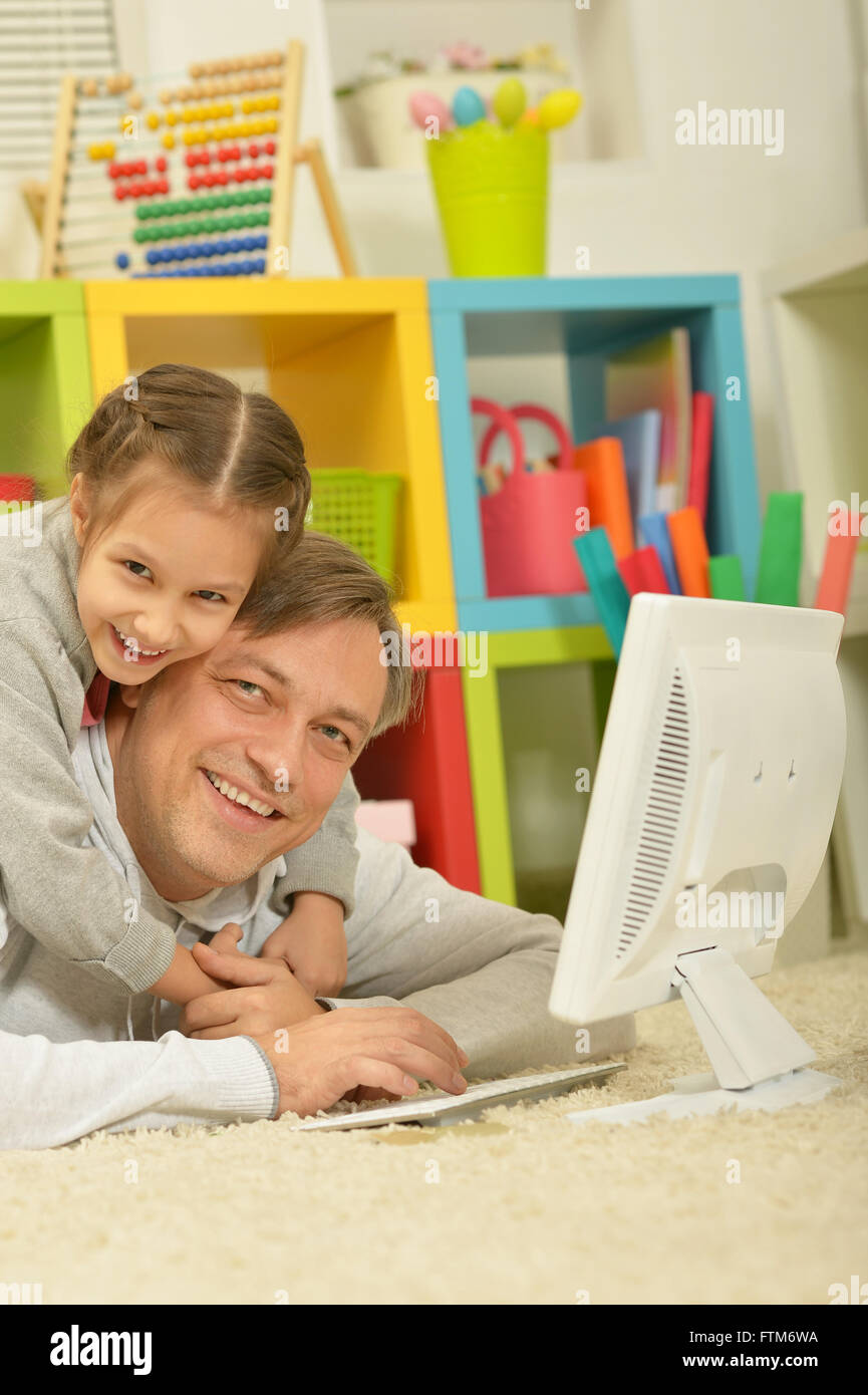 father and little daughter with computer Stock Photo - Alamy