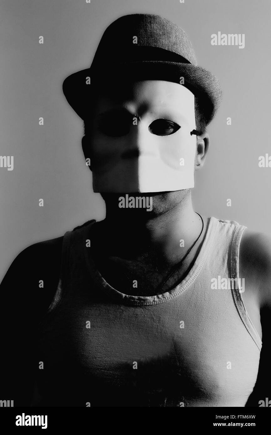 Portrait of a man wearing a suit and white masquerade mask Stock Photo ...