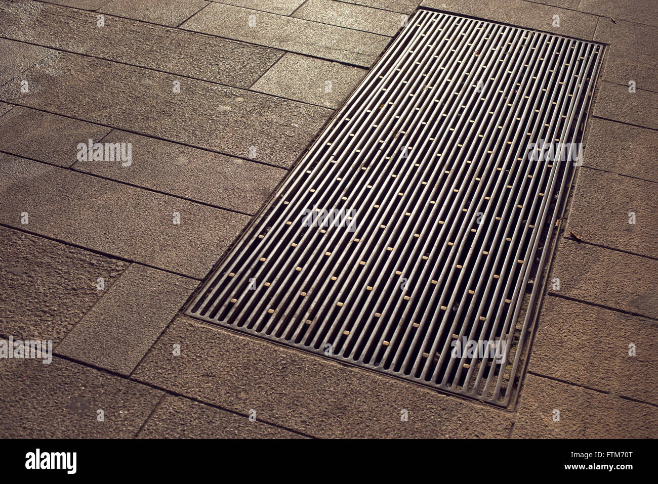 tiled city pavement fragment with big metallic drainage hatch Stock ...