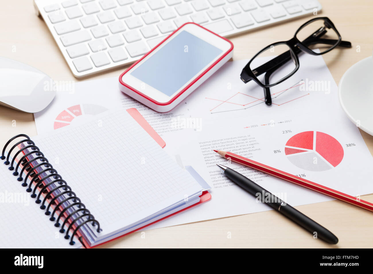 Office desk workplace with smart phone, charts and notepad on wooden ...