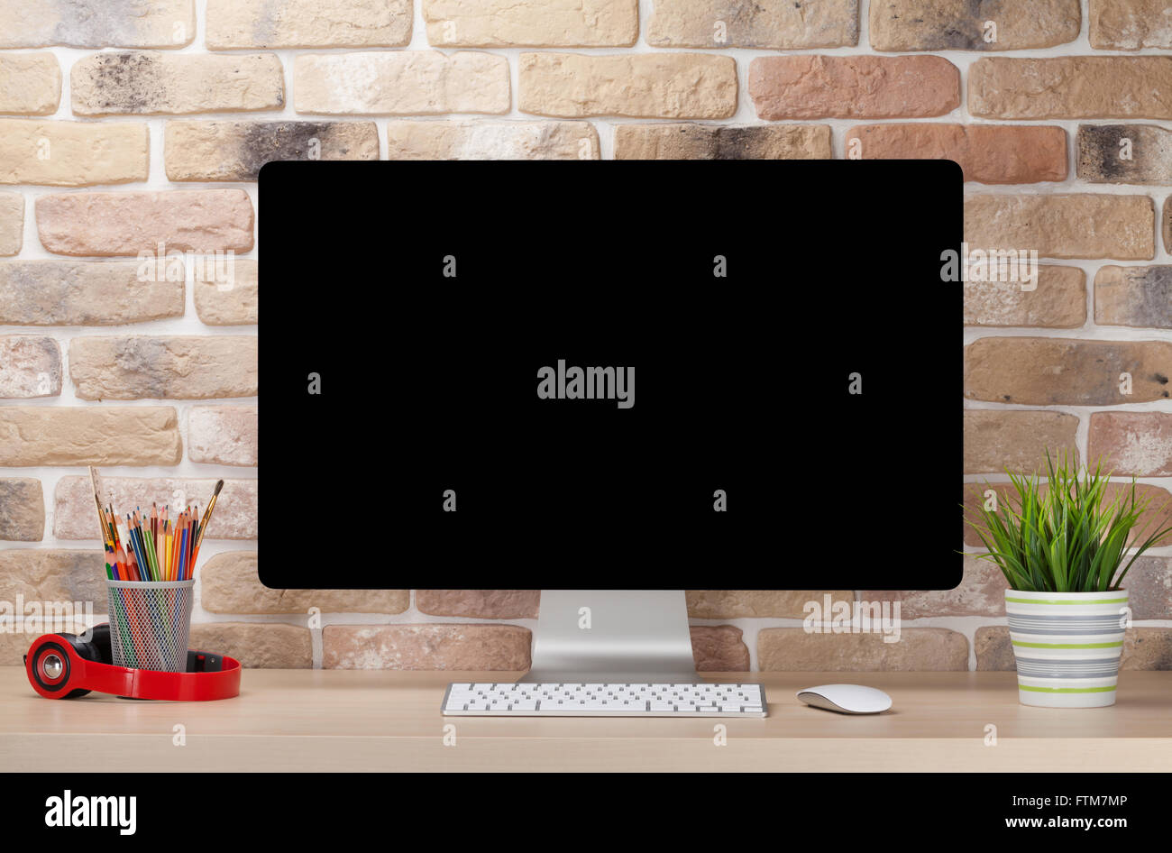 Office desk workplace with pc in front of brick wall. Loft style Stock ...