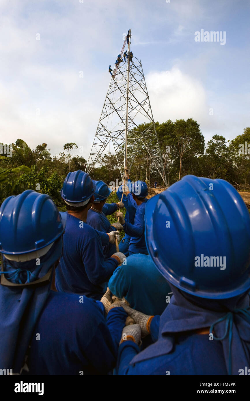Workmen erect the tower line of electricity transmission Stock Photo ...