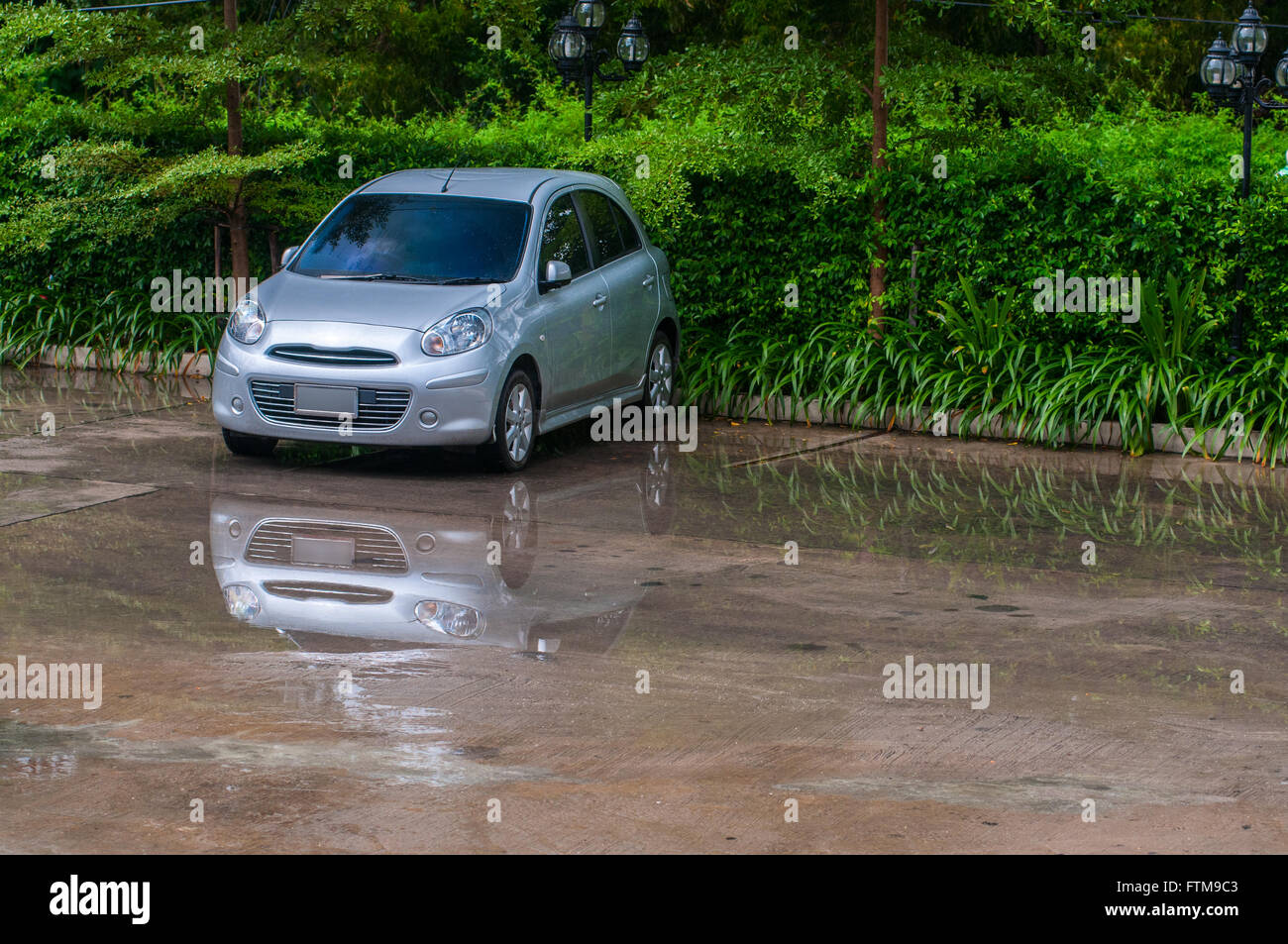 A car in a parking lot after the rain Stock Photo - Alamy