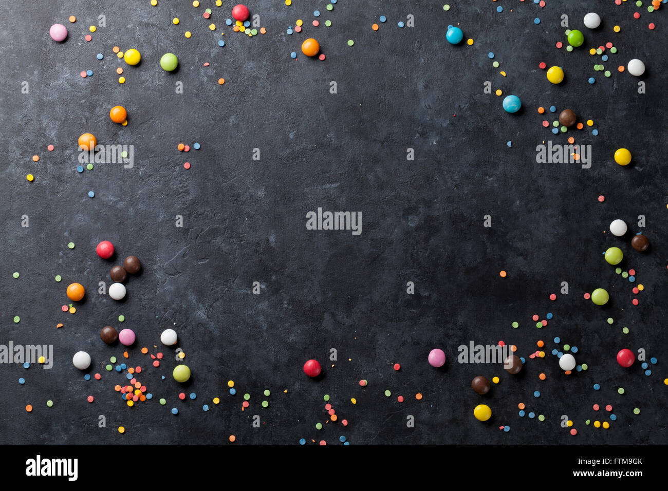 Colorful candies frame on stone background. Top view with copy space ...