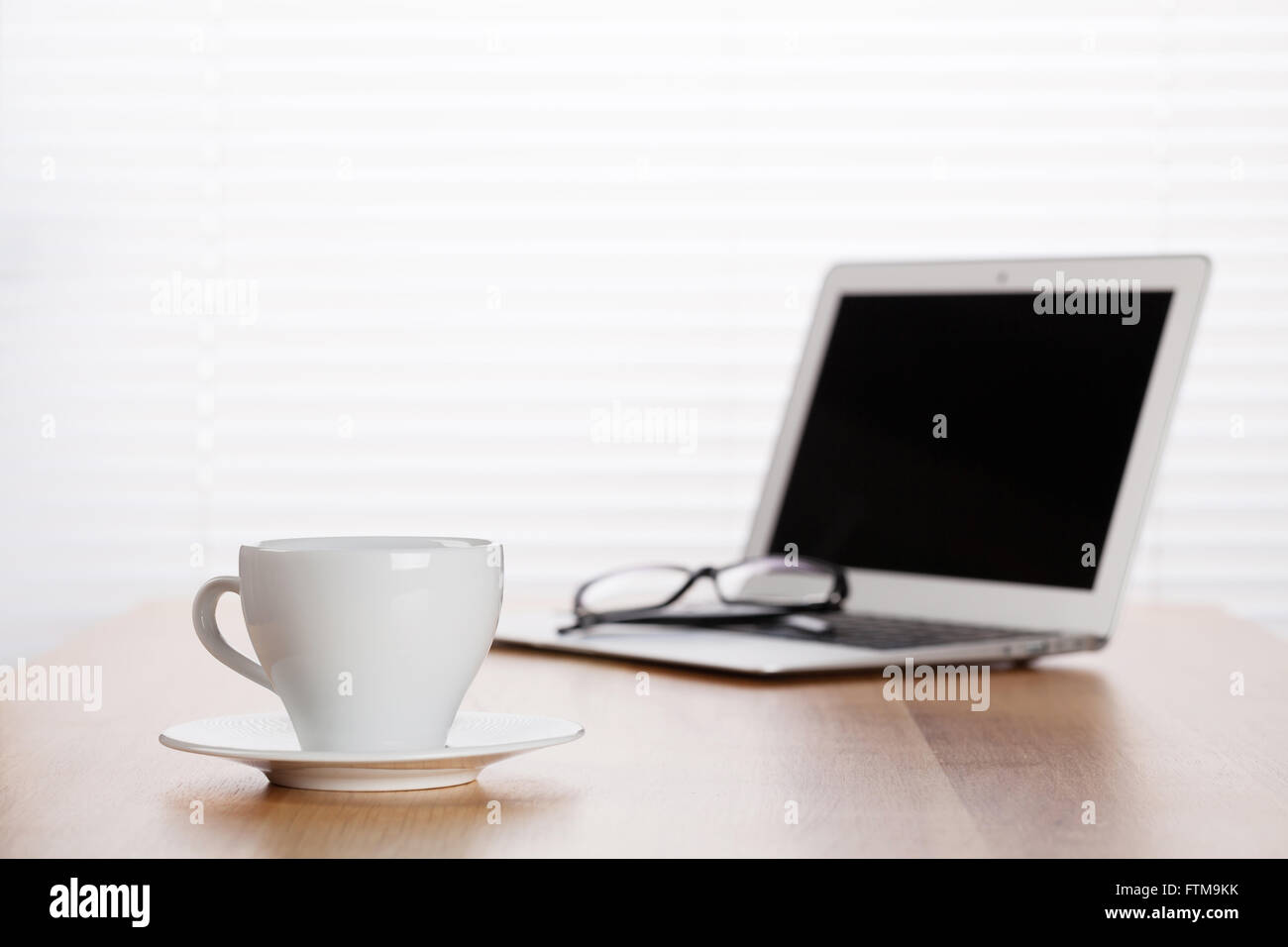 Office workplace with with laptop and coffee cup on wooden desk table ...