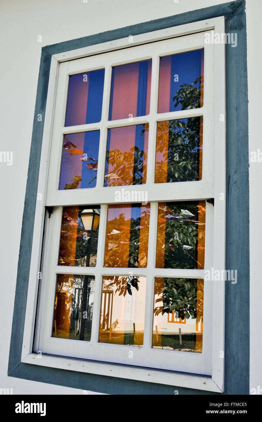 Window with reflection of city houses Pirenopolis Stock Photo - Alamy