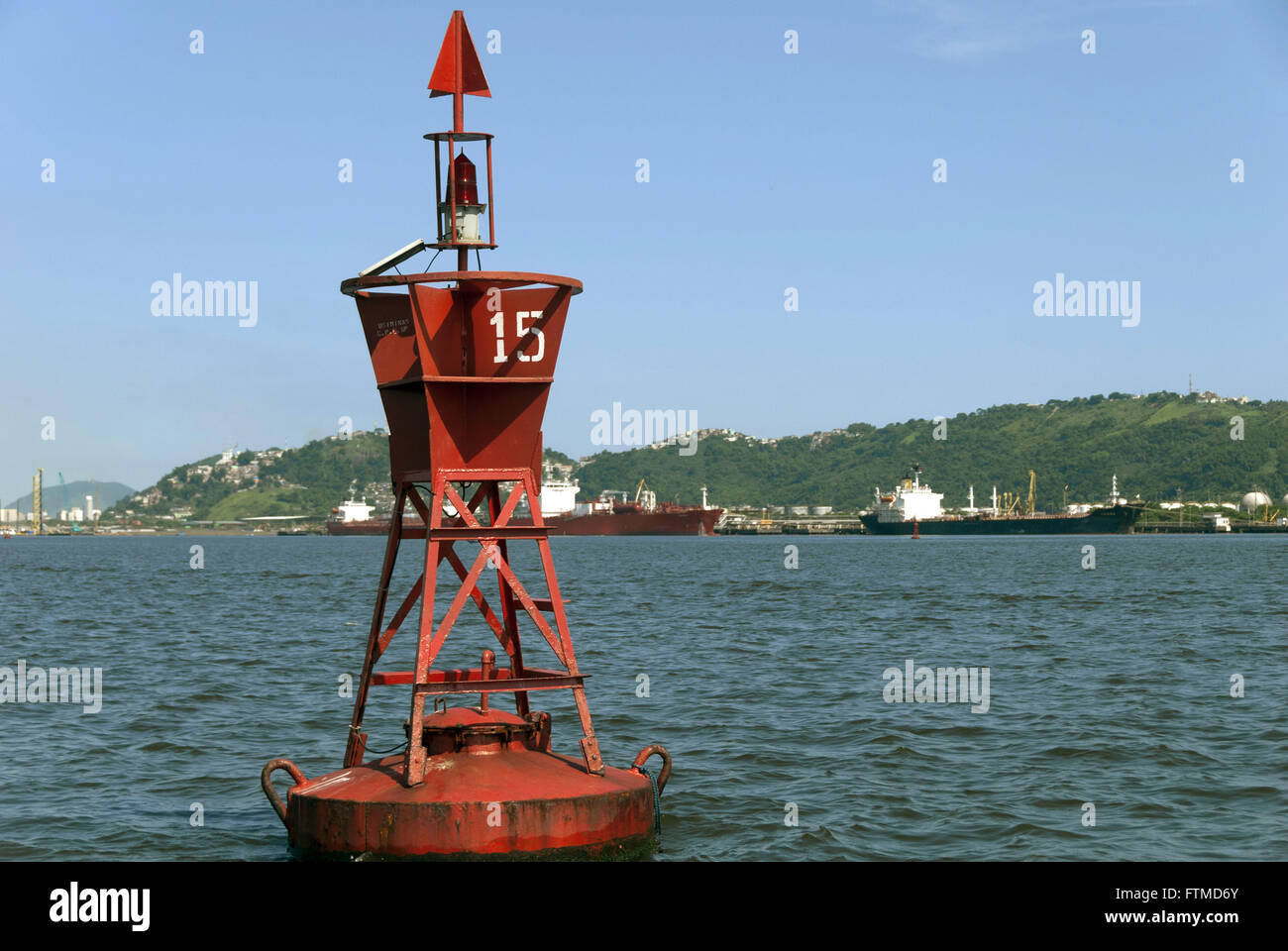 Buoy marking the channel with Santos bulk carriers moored at Pier ...
