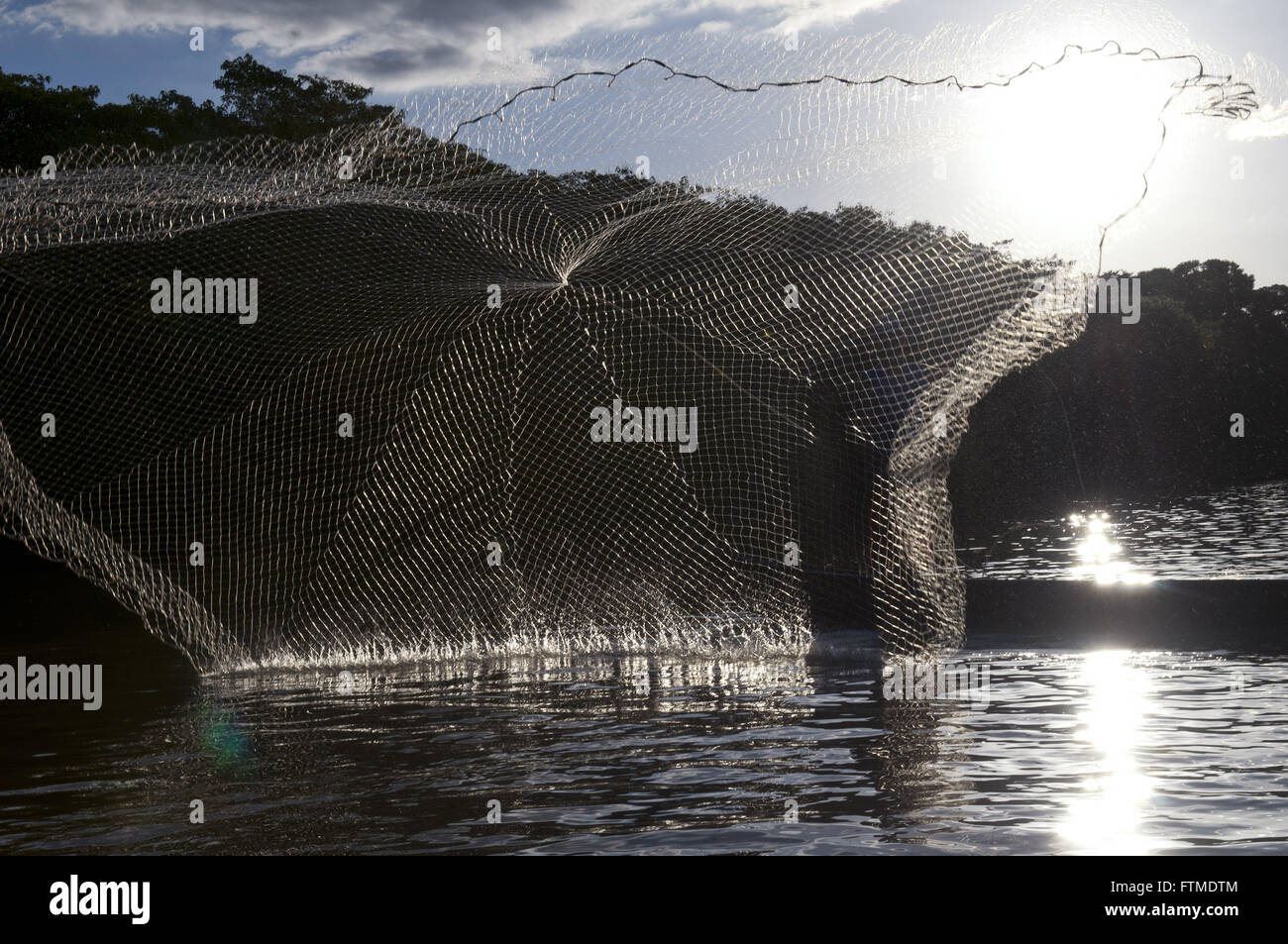 Fisherman casting a fishing net at Rio Sao Francisco - late afternoon ...