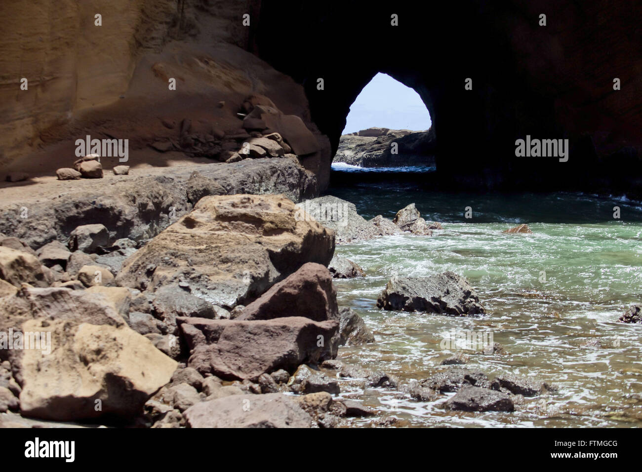 Volcanic rock pierced by the force of the water on the island of ...