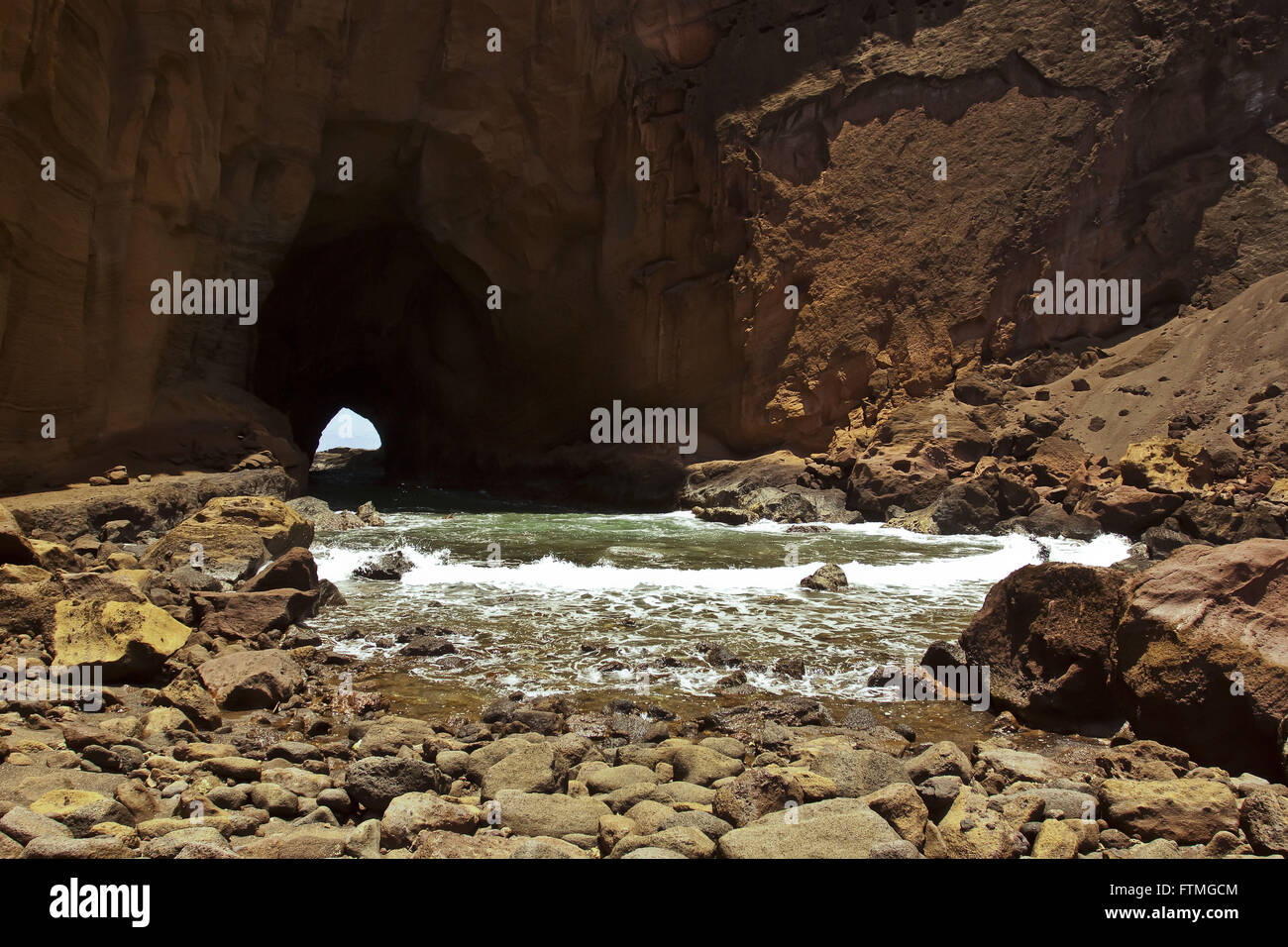 Volcanic rock pierced by the force of the water on the island of ...