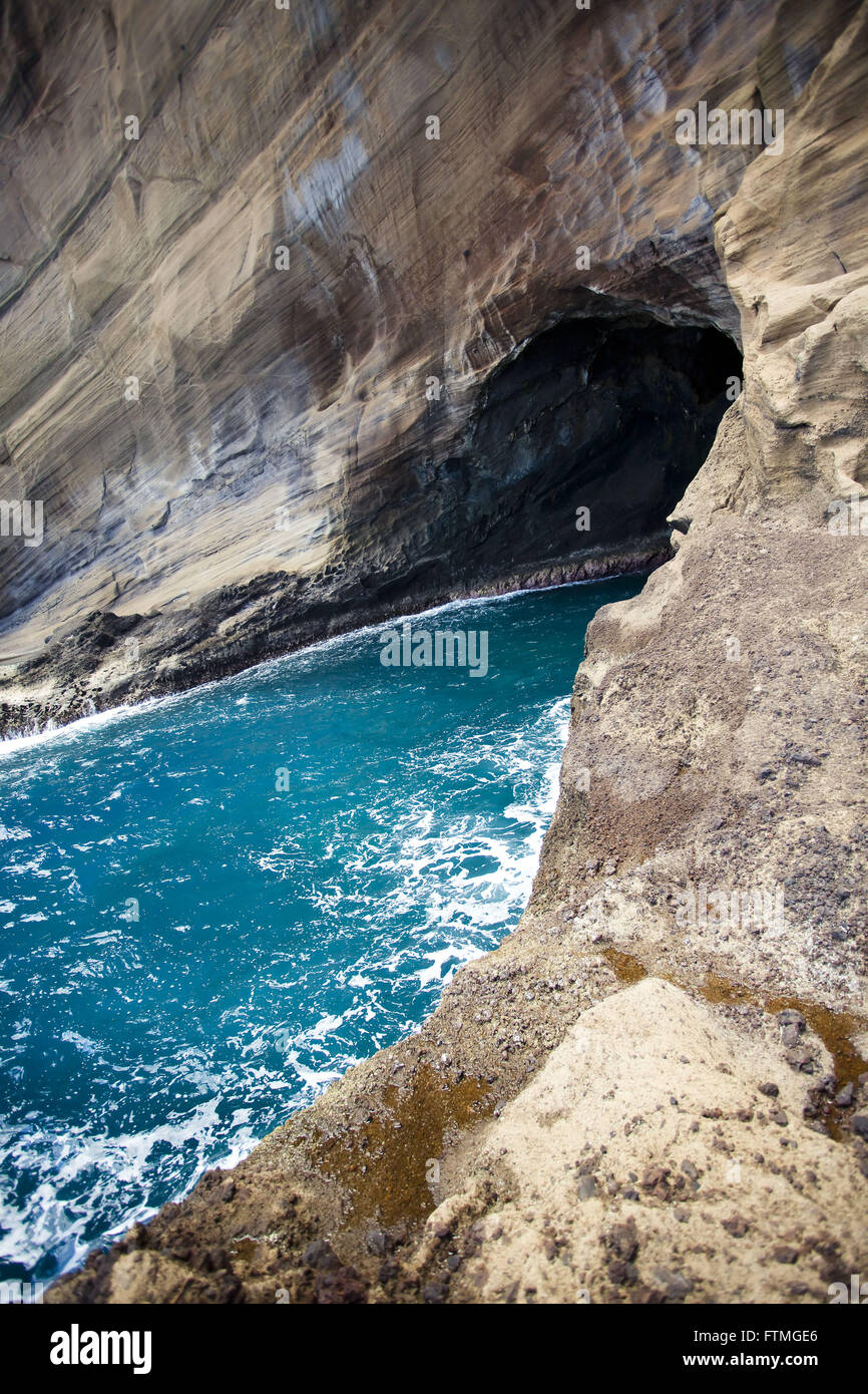 Volcanic rock pierced by the force of the water on the island of ...