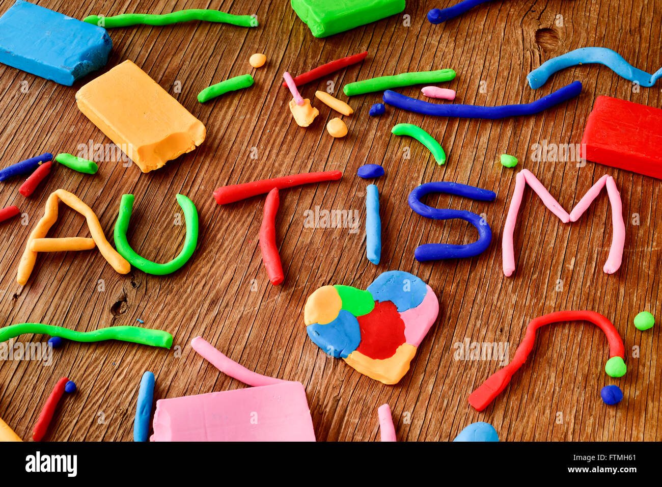 the word autism made from modelling clay of different colors on a ...