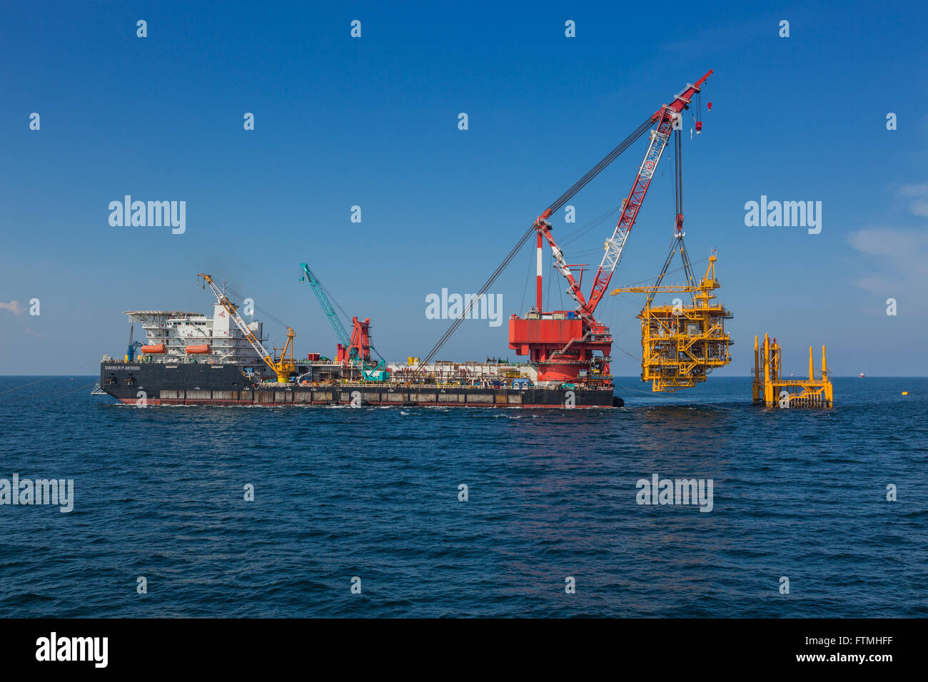Oil rig lifting for installation on its jacket Stock Photo - Alamy