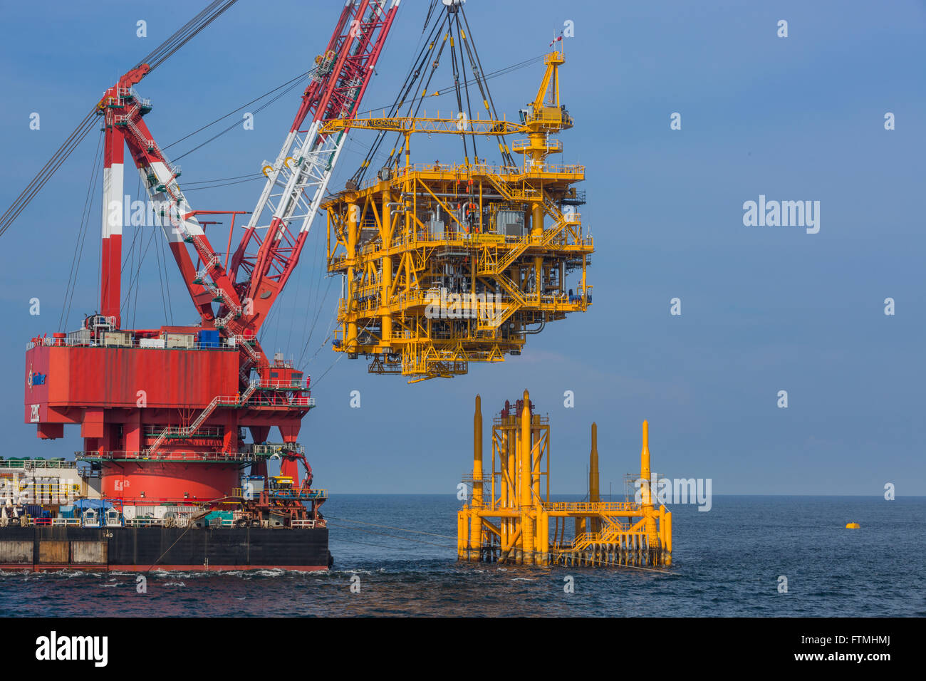 Oil rig lifting for installation on its jacket Stock Photo - Alamy