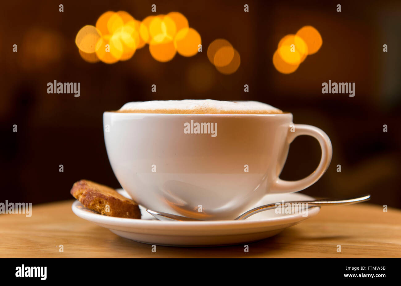 Caffe macchiato coffee drink in a long glass served in a coffee shop on ...