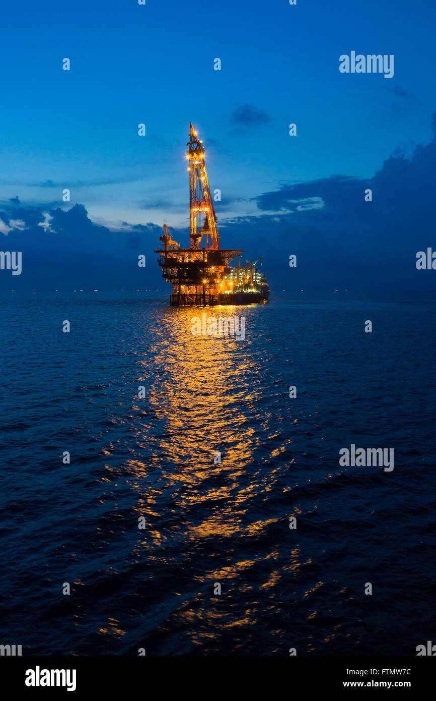 Crane barge and oil rig in the sunset Stock Photo - Alamy