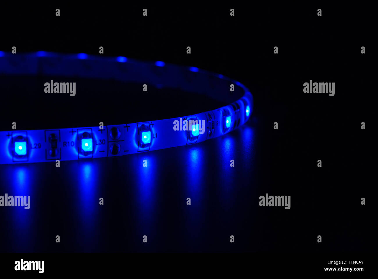 Blue led strip on the black background Stock Photo - Alamy