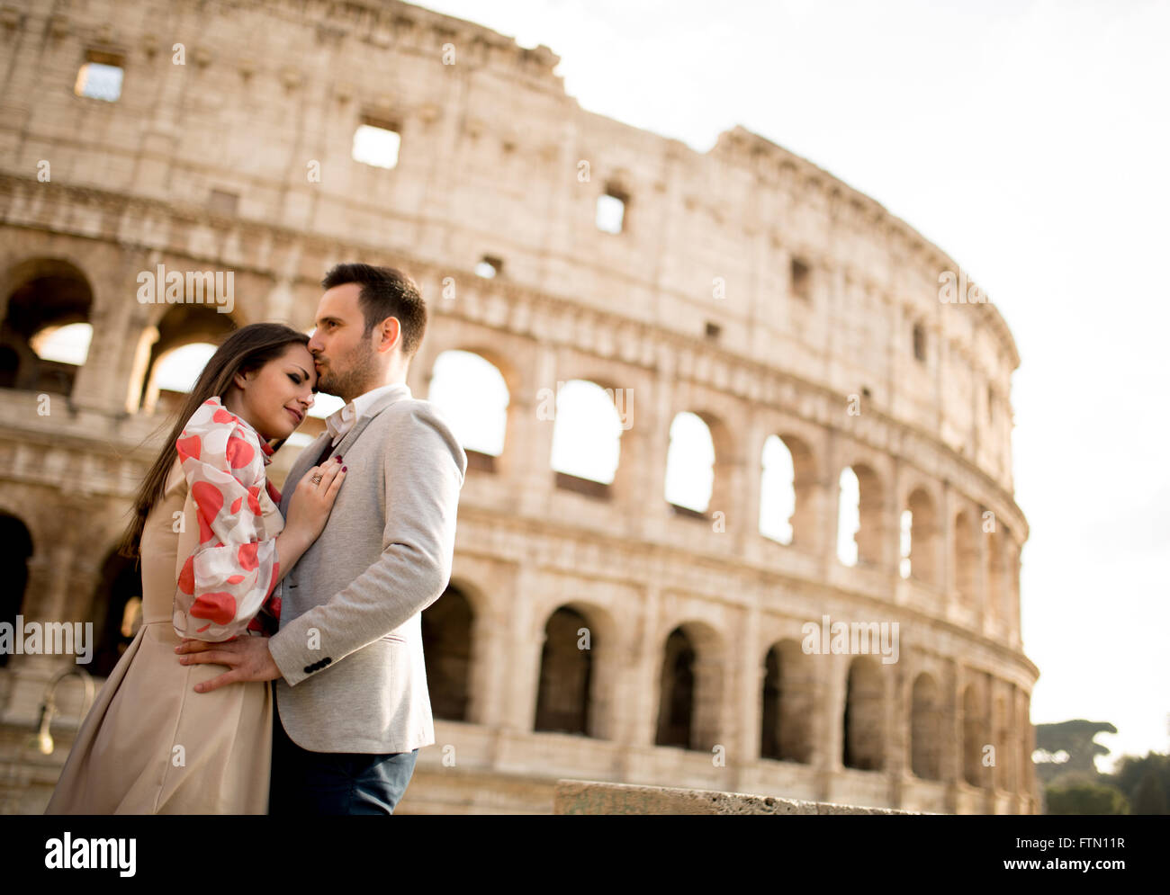 Loving couple in front of the Colosseum in Rome Stock Photo - Alamy