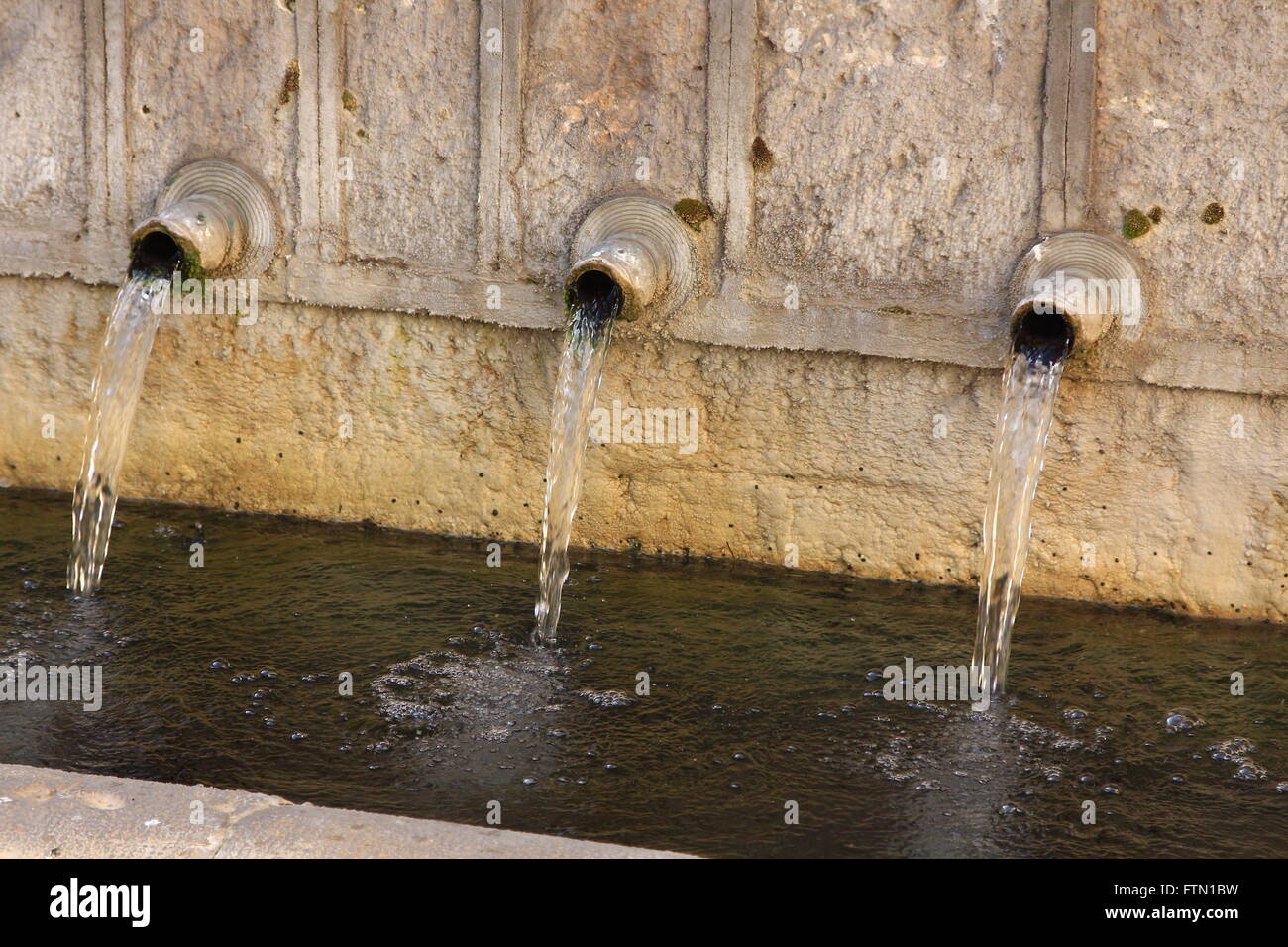 ancient water fountain water pipes Stock Photo - Alamy