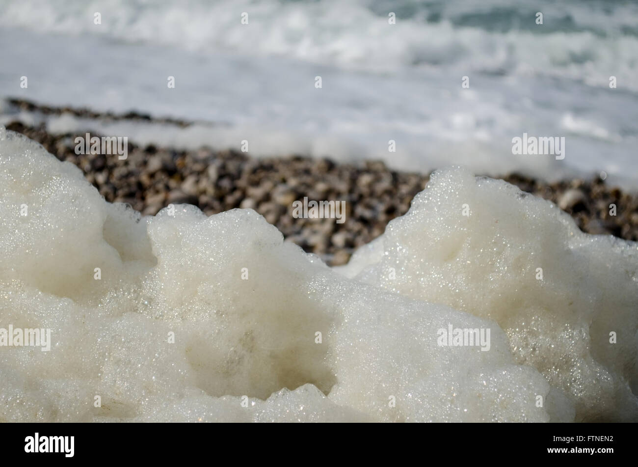 Foam on the beach Stock Photo - Alamy