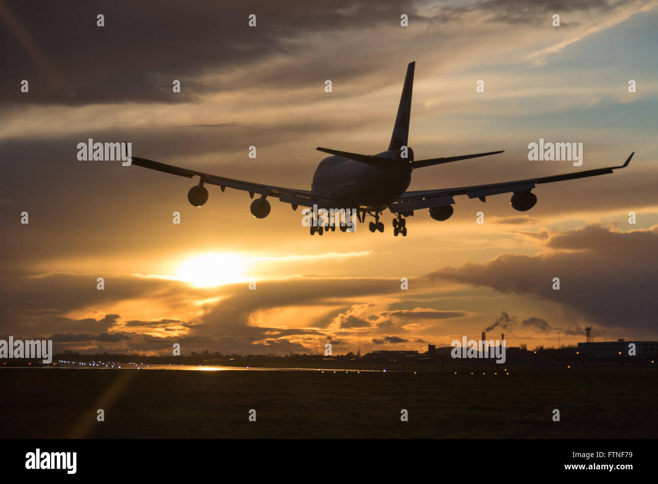 A British Airways Boeing 747-400 lands at London Heathrow as the sunset ...