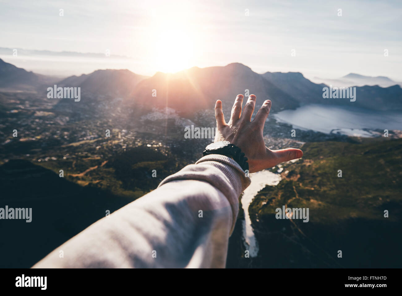 Hand of a man reaching out the beautiful landscape. POV shot of human ...