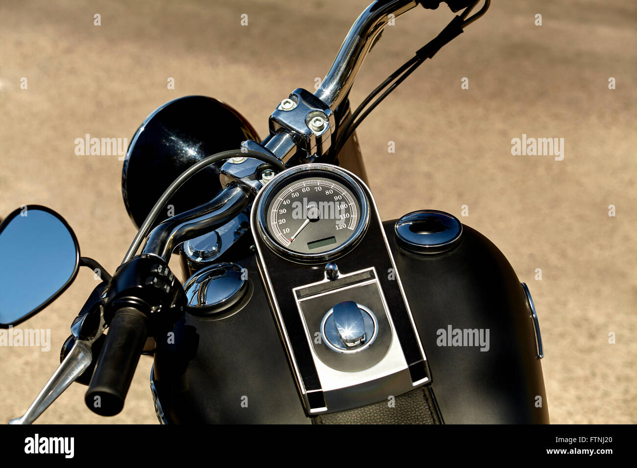 Black motorcycle speedometer with odometer, ignition switch, handlebars ...