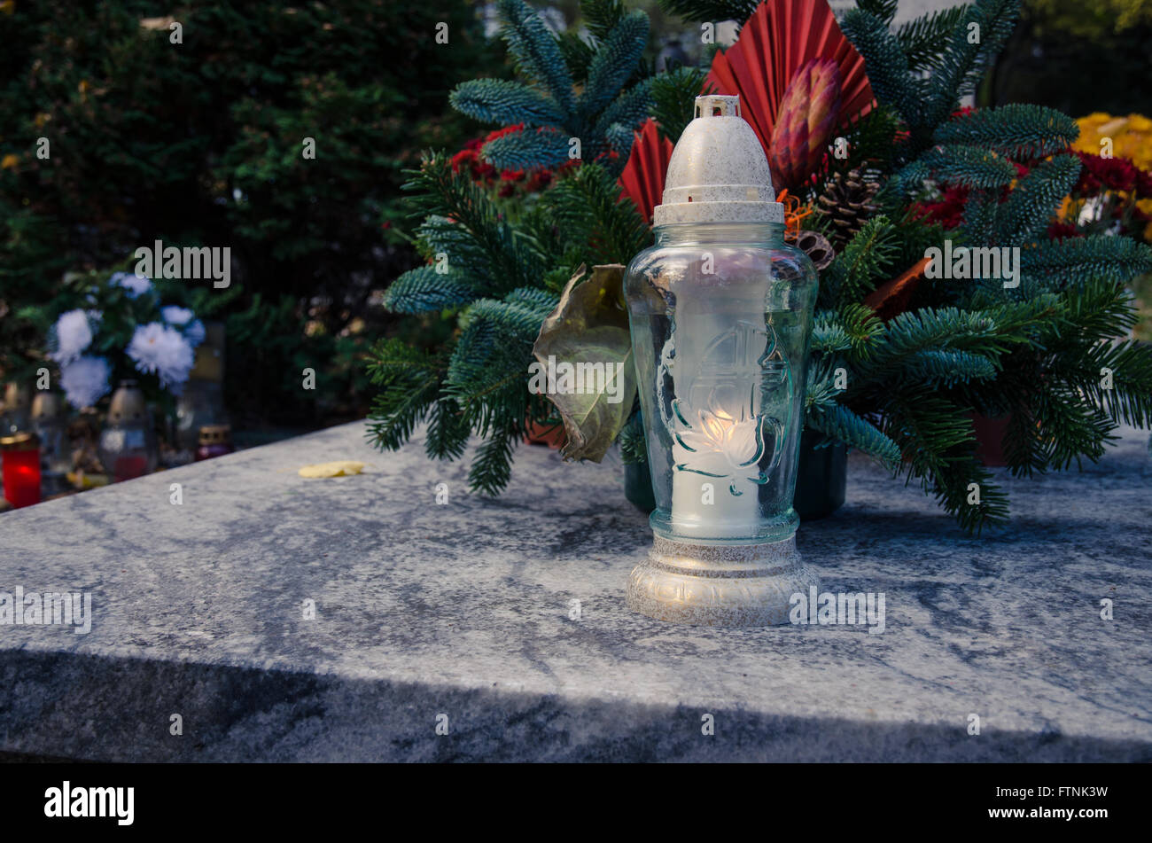 lantern with burning candle on the grave Stock Photo - Alamy
