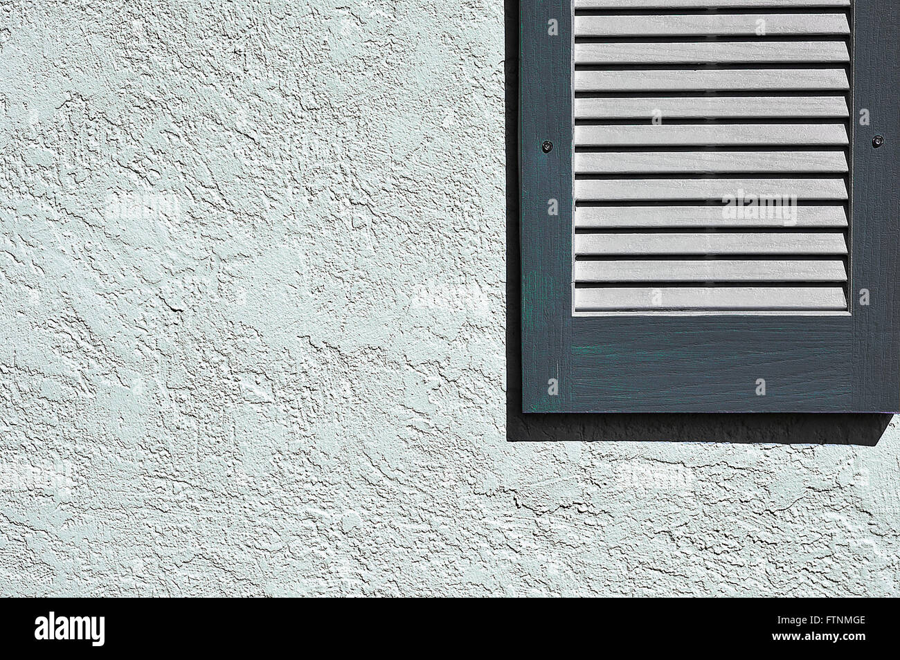 Slate Blue Shutter on Exterior Stucco Wall Stock Photo - Alamy