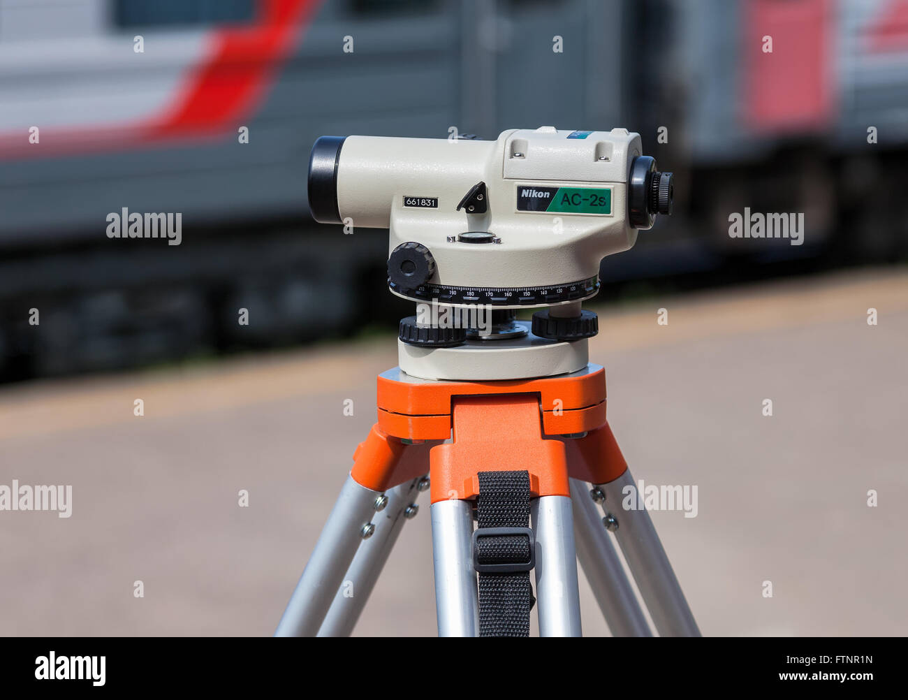 Geodetic equipment optical level mounted on tripod at the railway ...