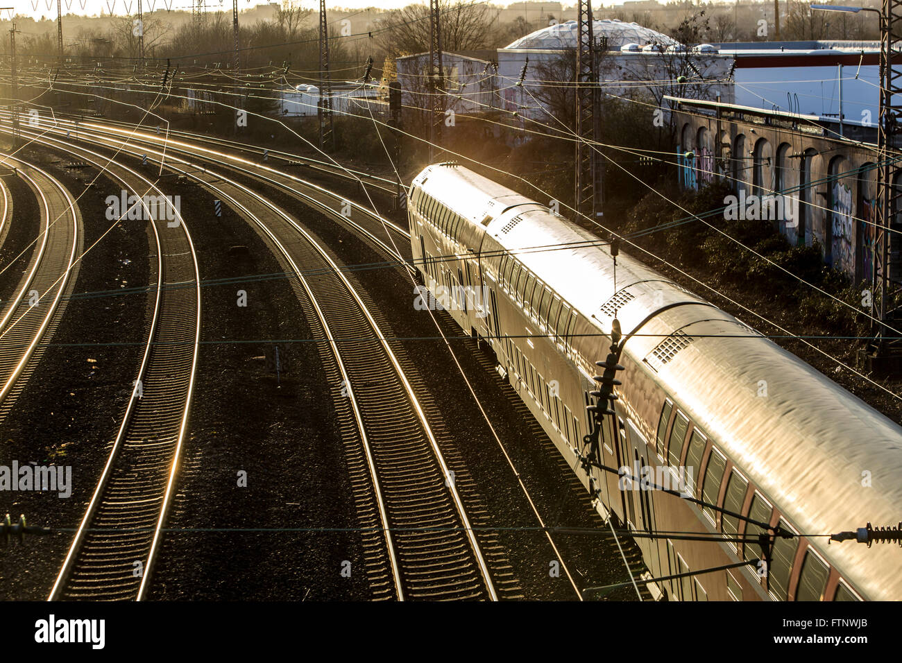 Railroad tracks, reflecting the sunlight, train on tracks Stock Photo ...