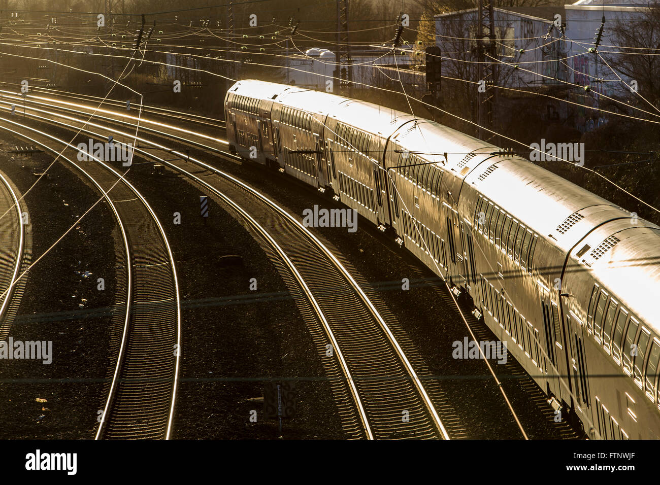 Railroad tracks, reflecting the sunlight, train on tracks Stock Photo ...